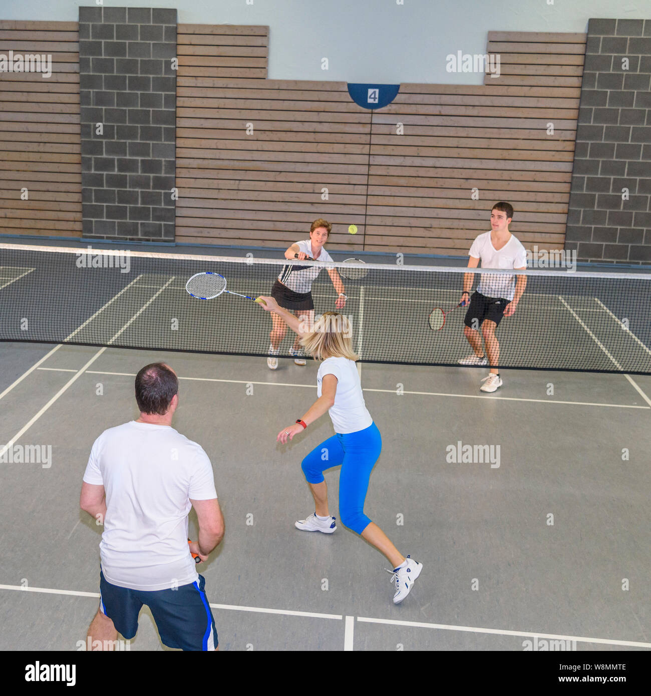 Badminton game scene in sports hall, a lot of effort and commitment ...