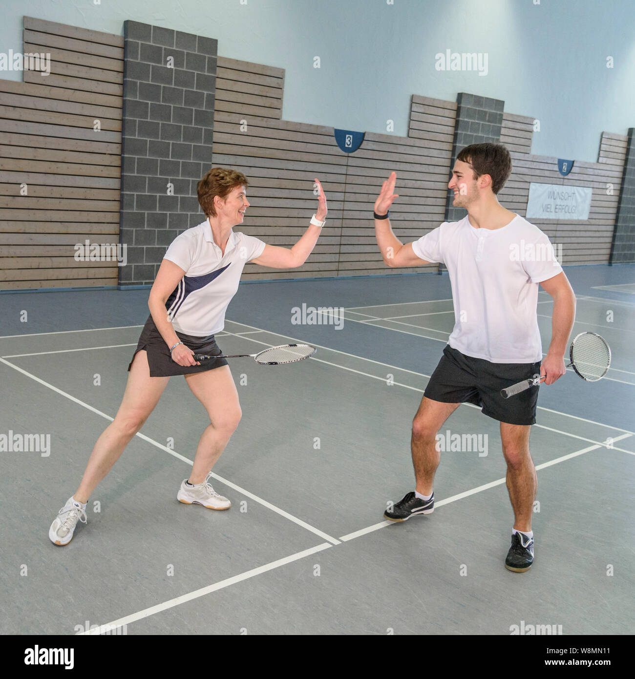 Badminton game scene in sports hall, a lot of effort and commitment ...