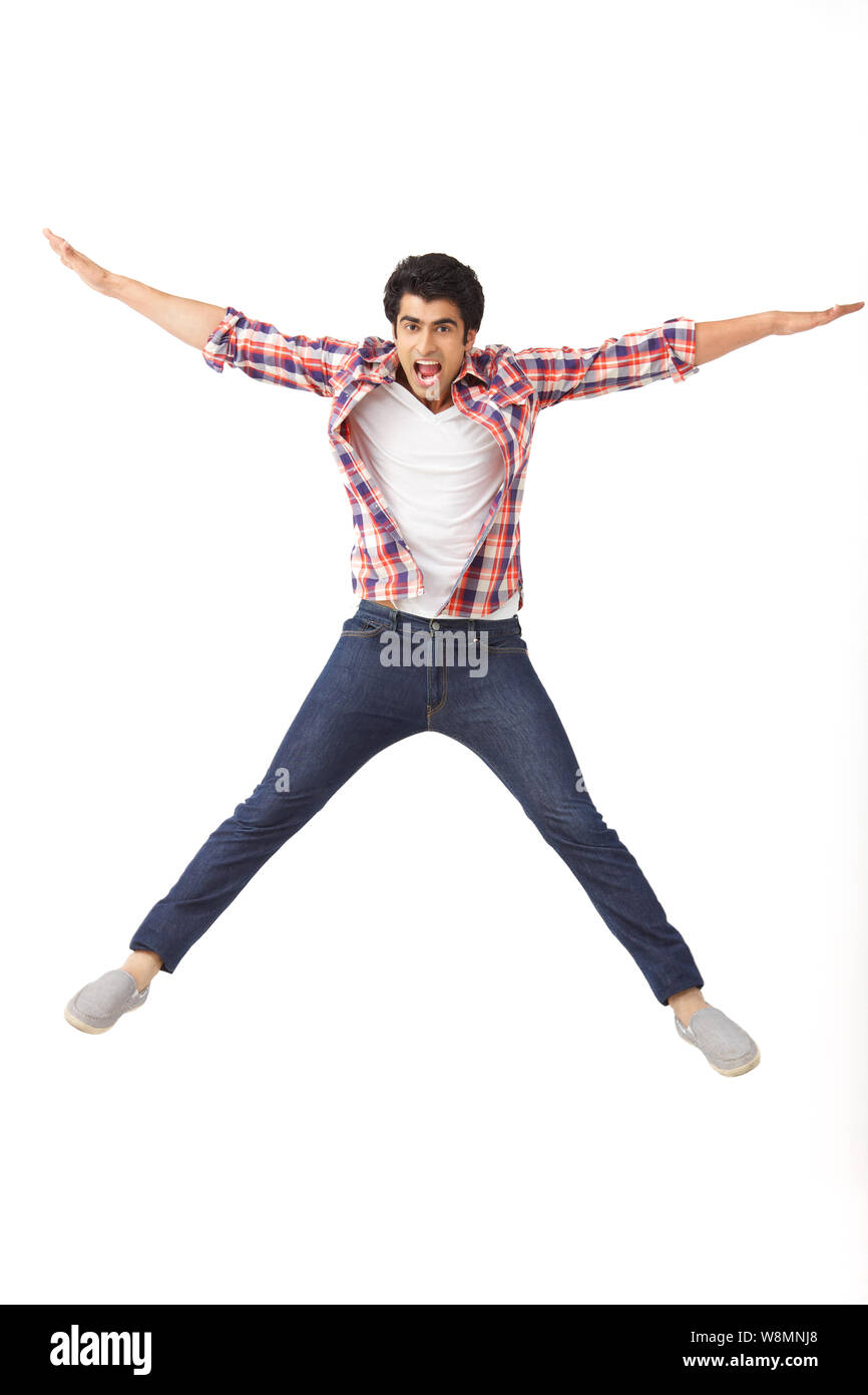 Young man jumping in mid air Stock Photo - Alamy