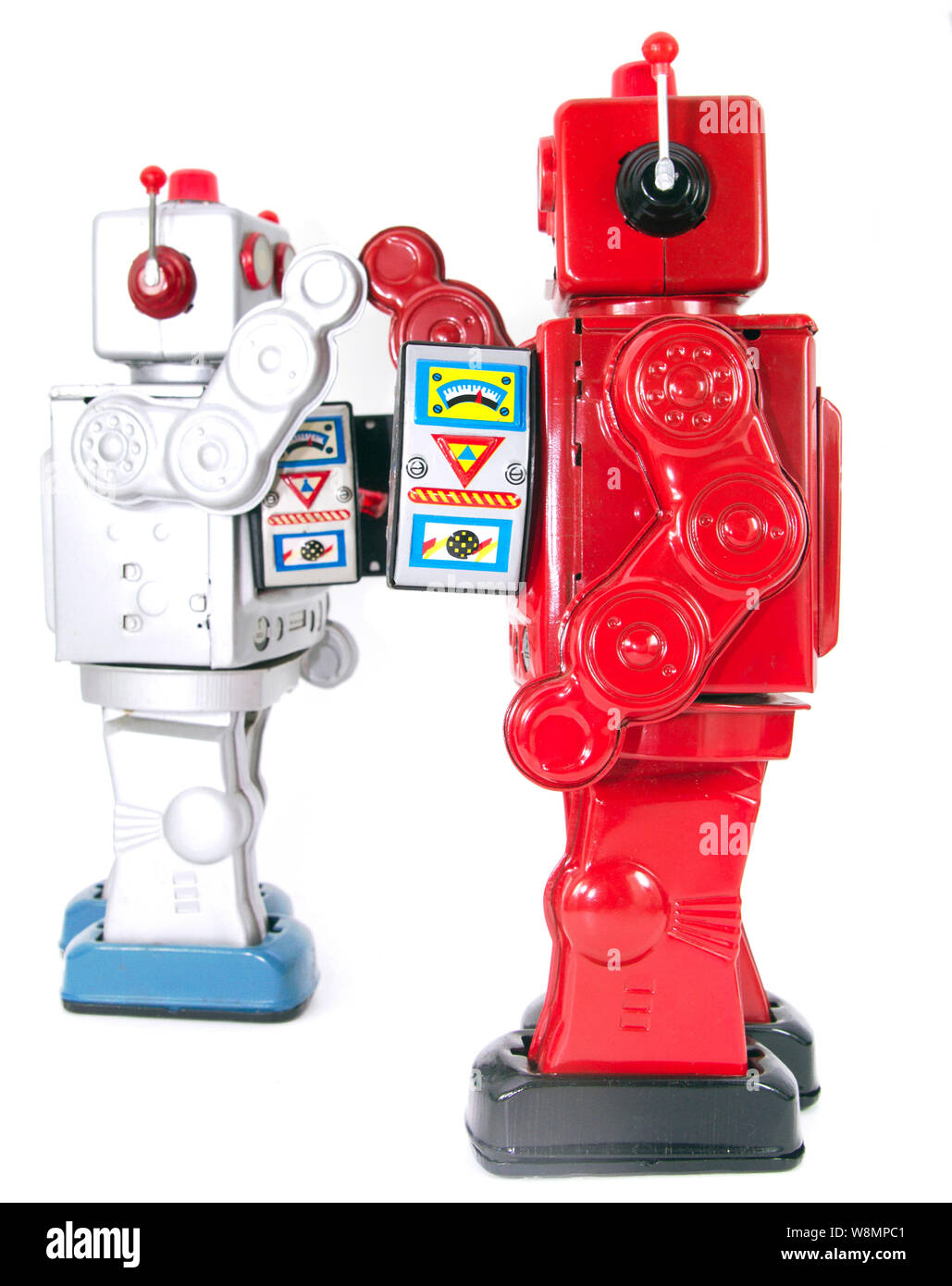 two retro robots high five each other isolated on white Stock Photo - Alamy