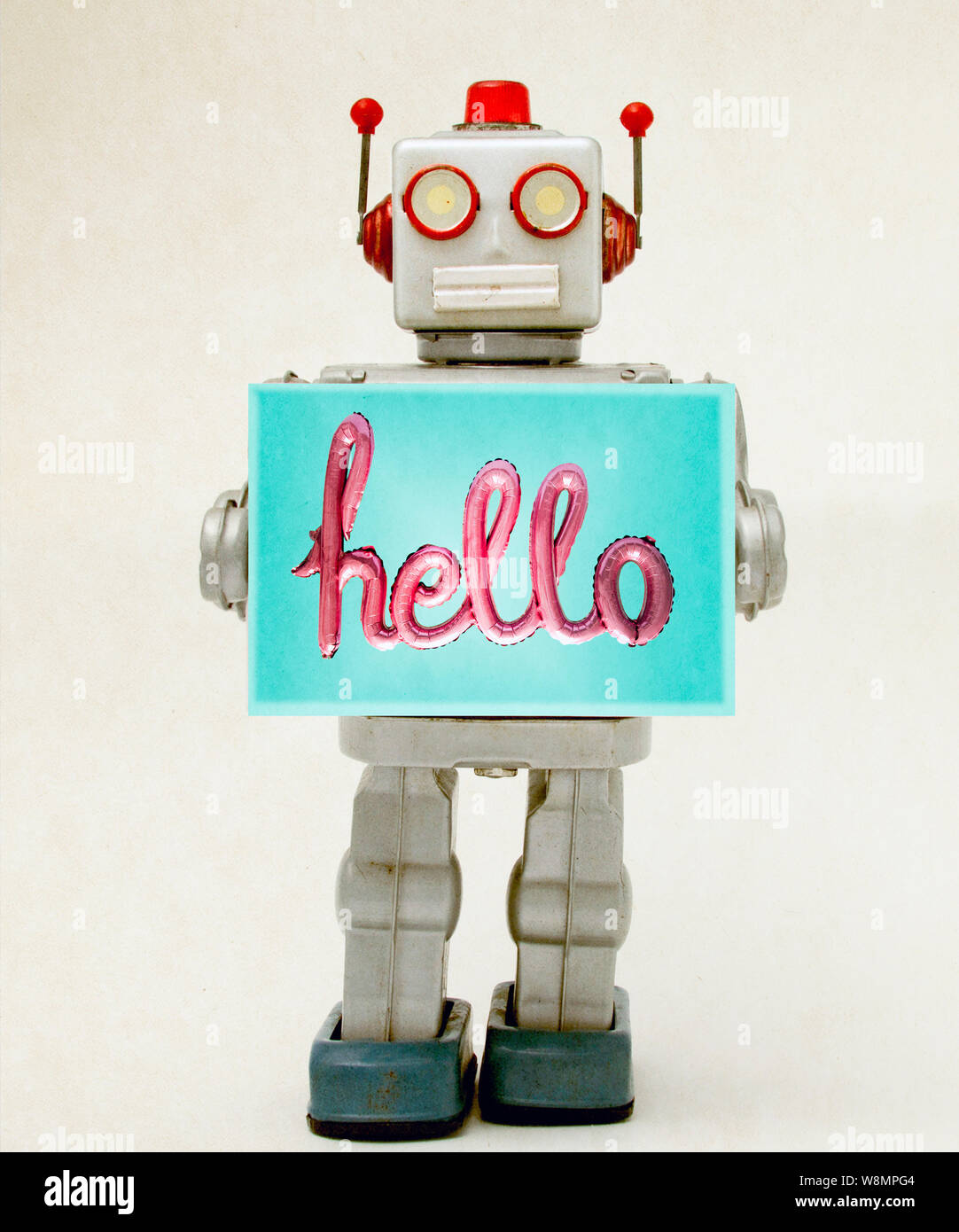 robot toy holding a hello sign toned image Stock Photo - Alamy