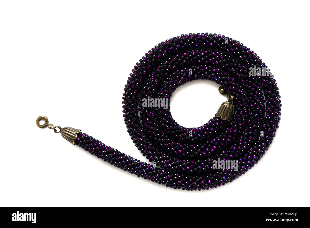 Long beaded rope purple color isolated on white background close up ...