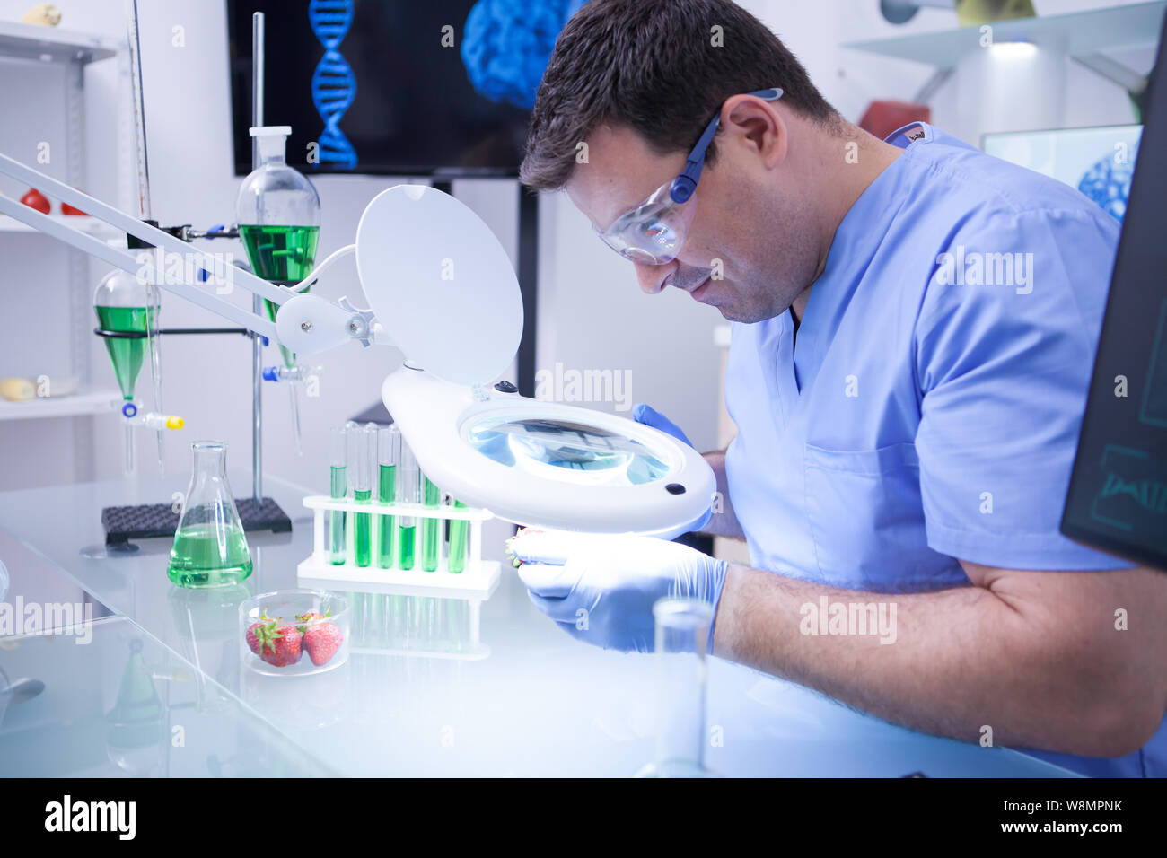 Young scientist man wearing protection glasses in a research lab ...