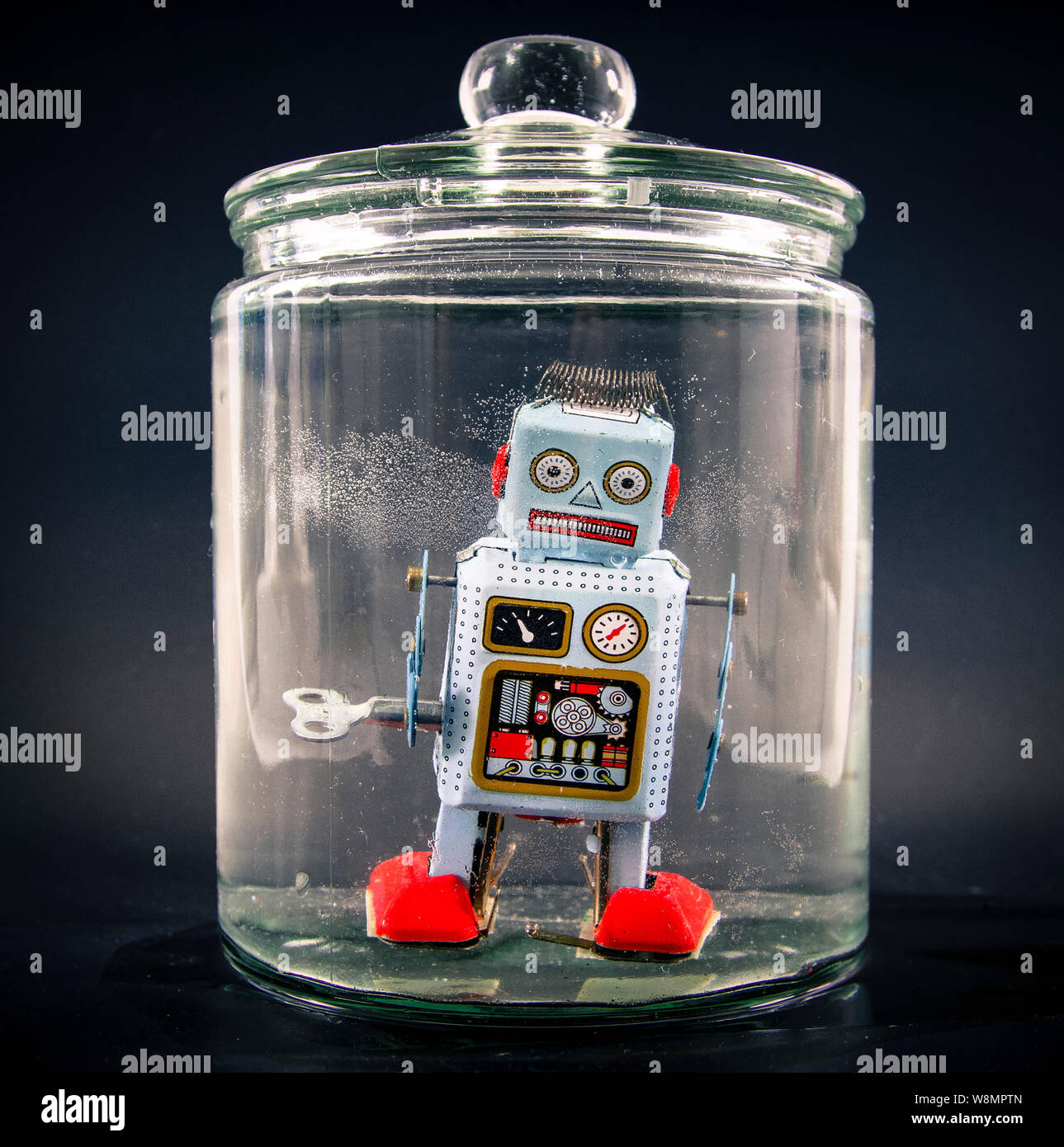 retro robot toy trapped in a gleass jar Stock Photo - Alamy
