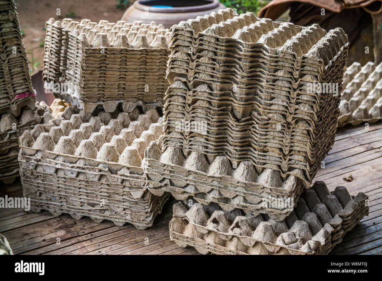 Paper egg support egg carton trey stack on wood table Stock Photo - Alamy