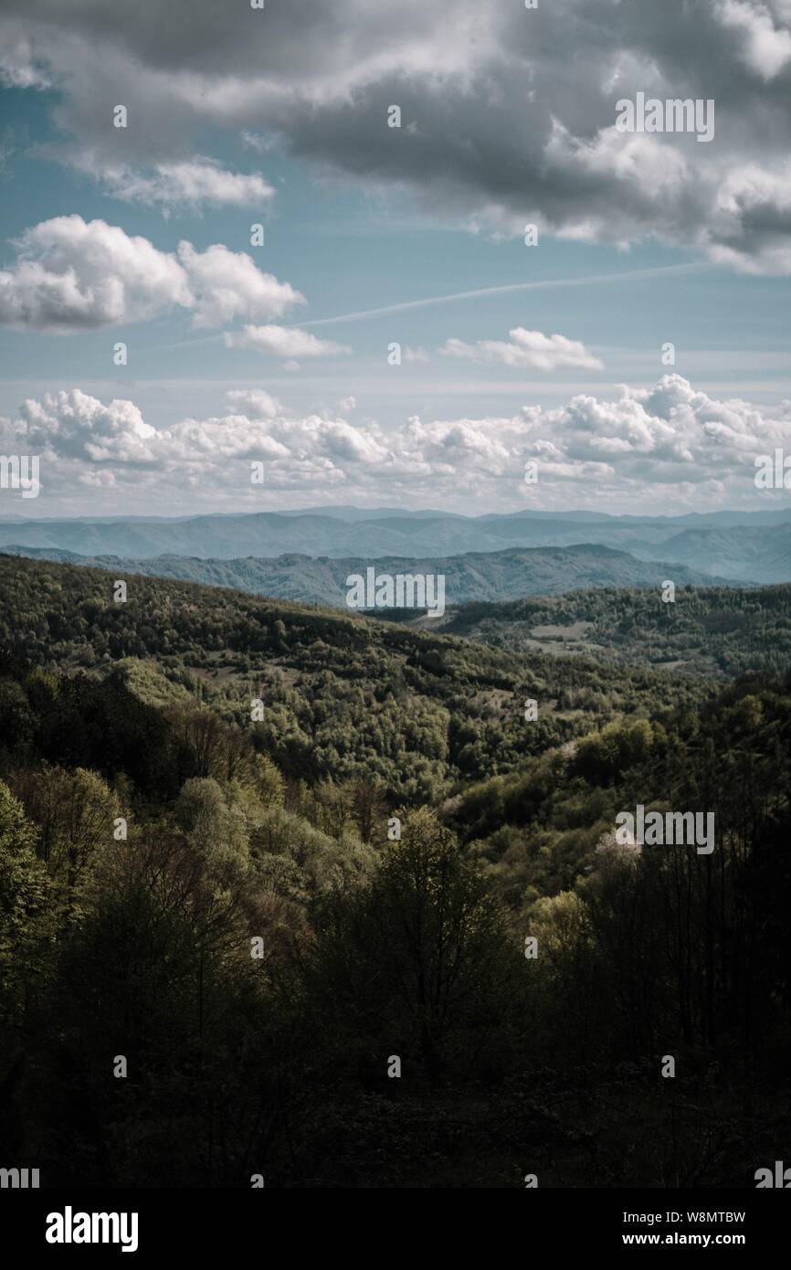 Vertical shot of beautiful mountains and hills with amazing clouds in ...