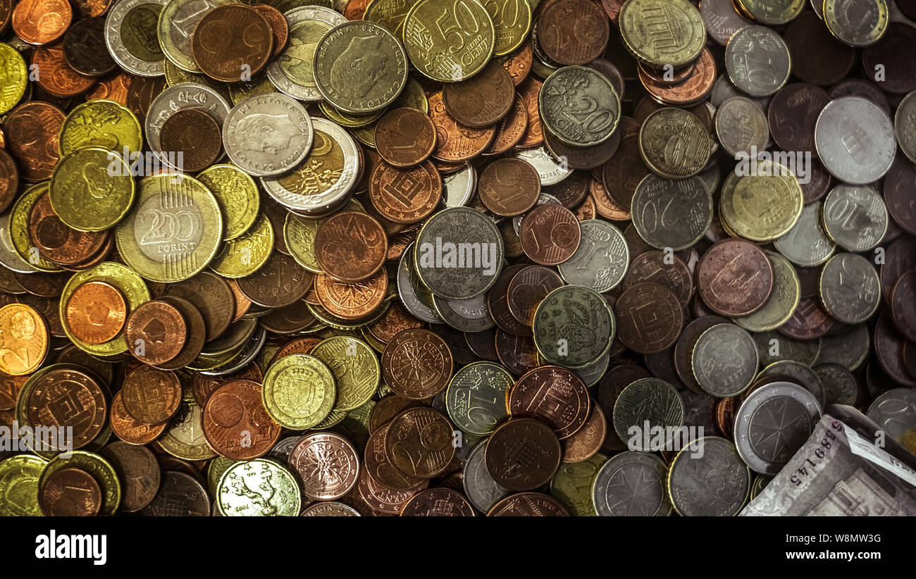 pile of coins from different countries Stock Photo - Alamy