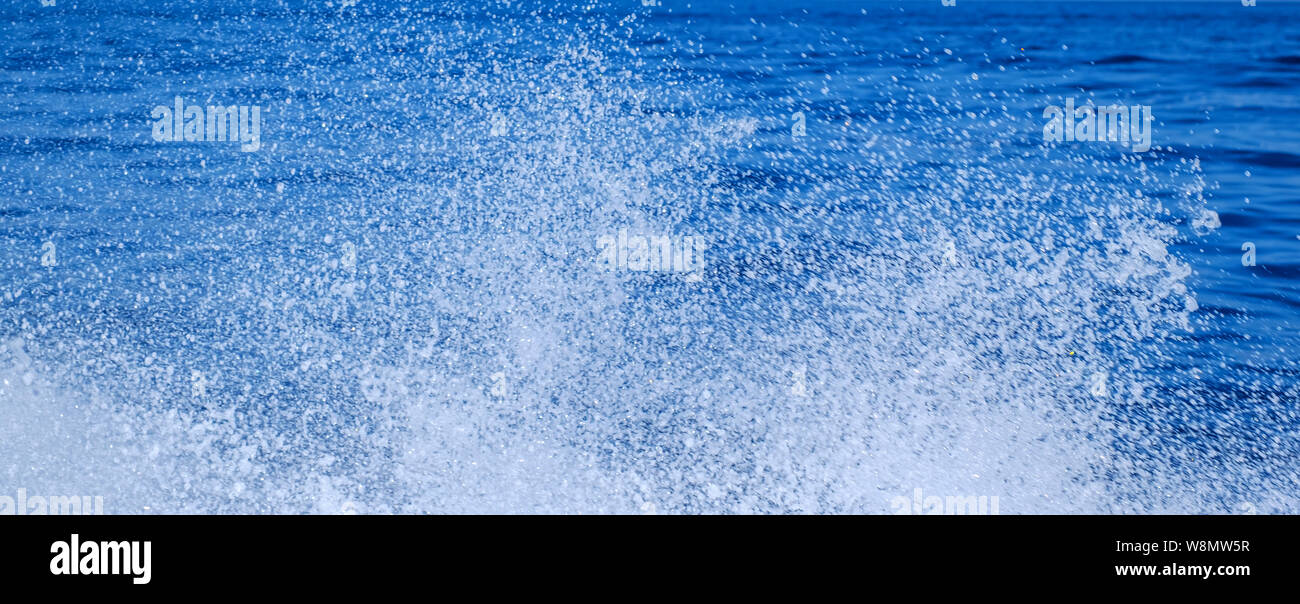 Blue ocean sea water wave with fast yacht boat wake foam of prop wash ...