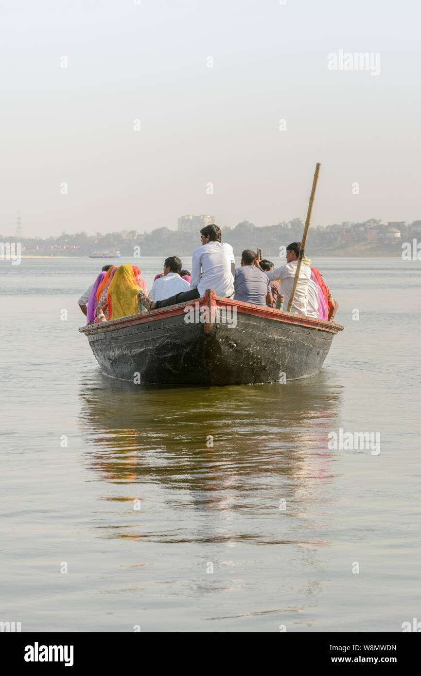Indian pilgrims enjoy a boat ride on the River Ganges in Varanasi ...