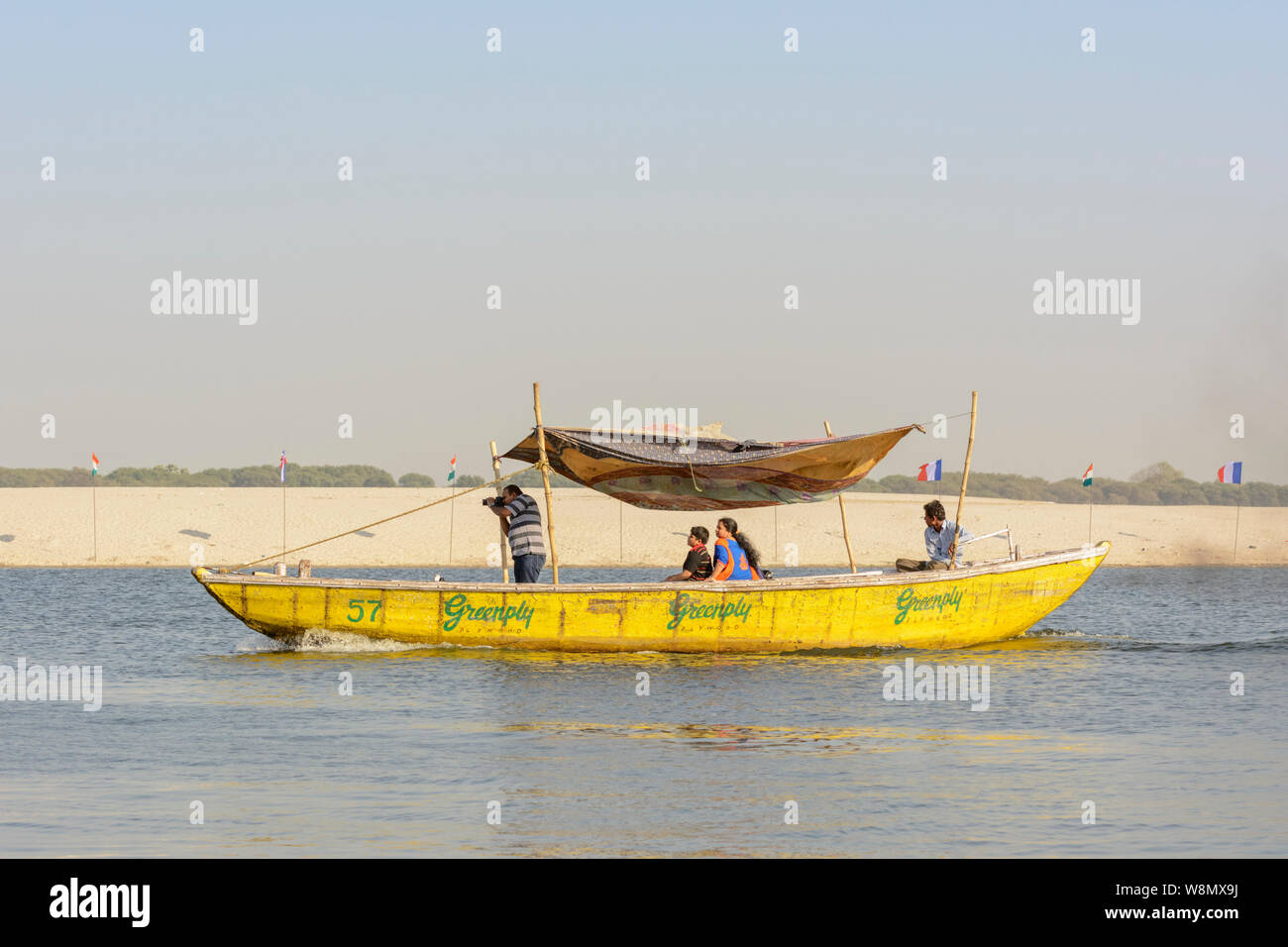 Indian tourists enjoy a boat ride on the River Ganges in Varanasi ...