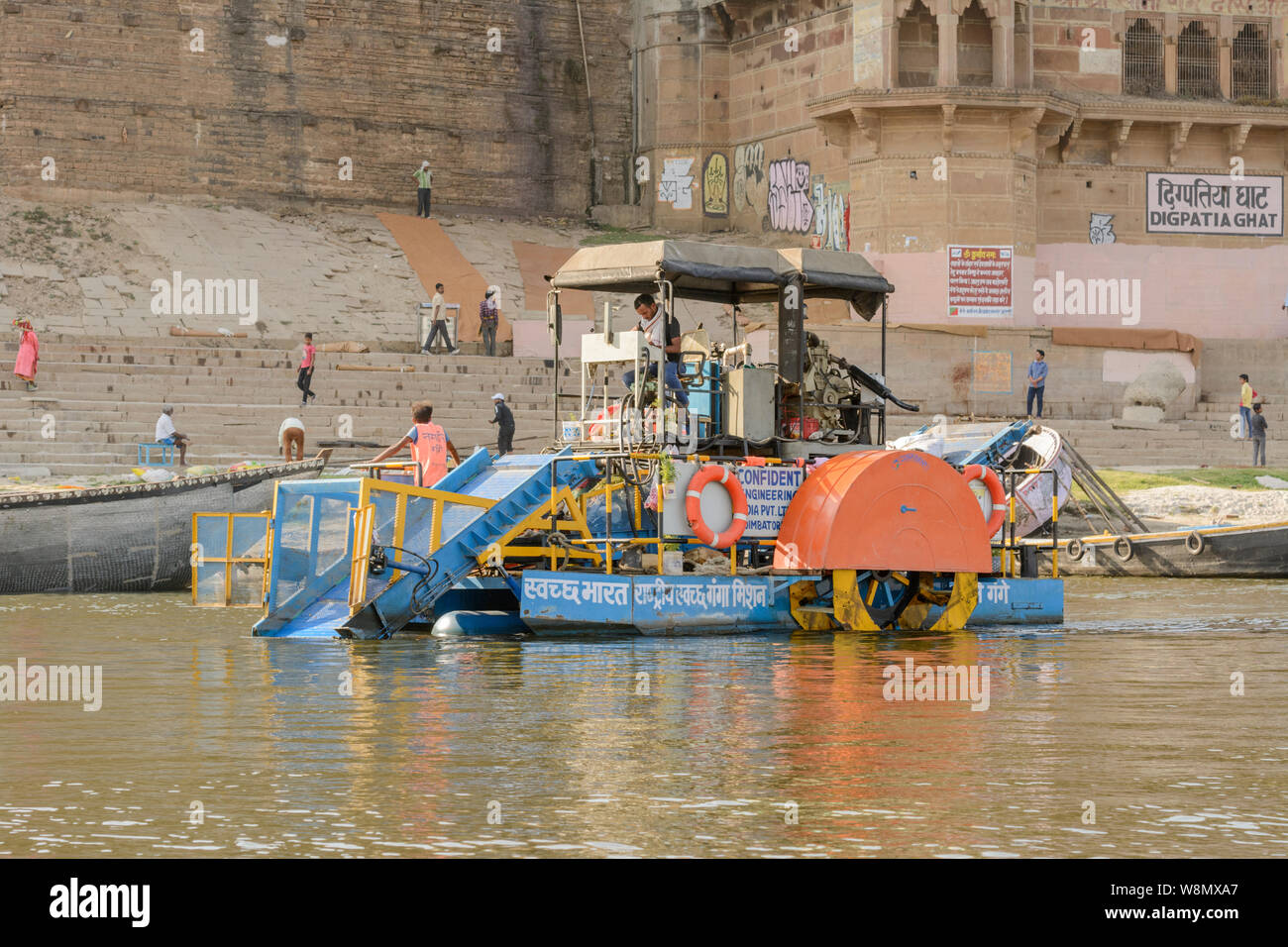 Trash skimmer machines remove floating waste from the surface of the ...