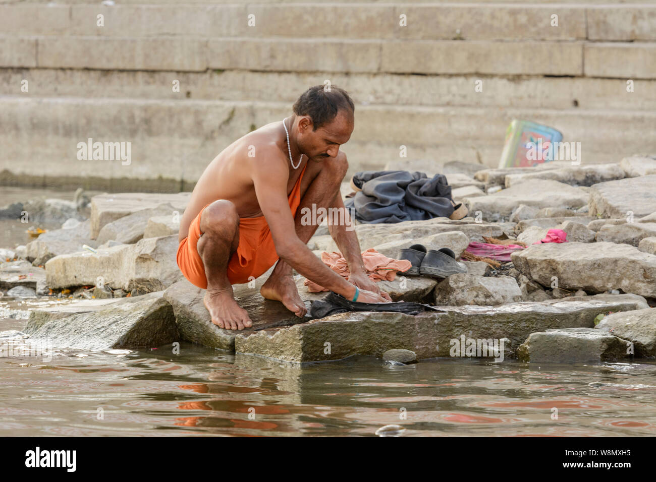Man Washing Clothes By Hand