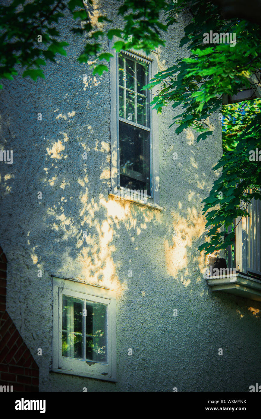 Windows on a plaster wall of a traditional mansion in Toronto suburbs ...