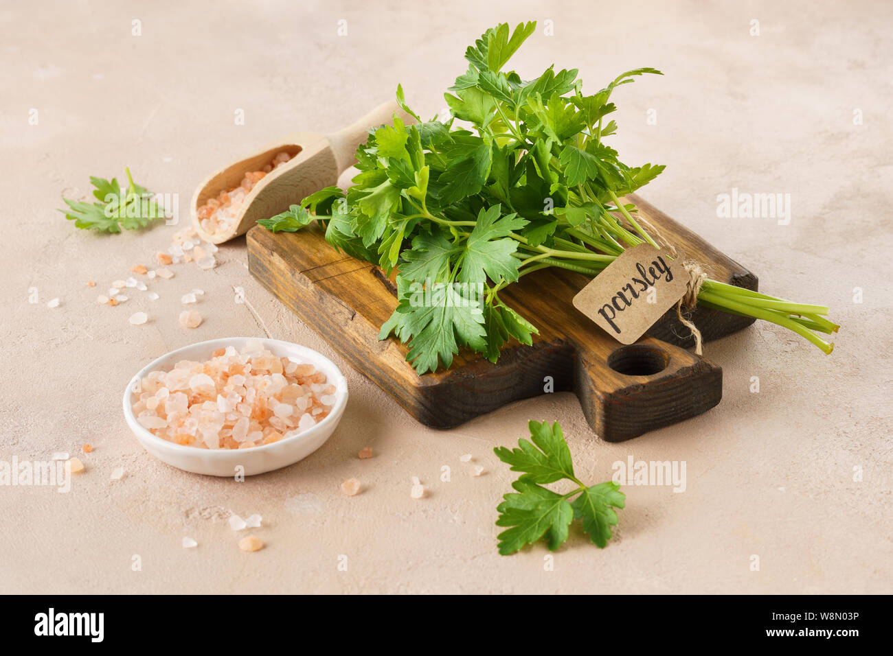 Pink Himalayan salt and a bunch of fresh parsley with a tag. Herbs and ...