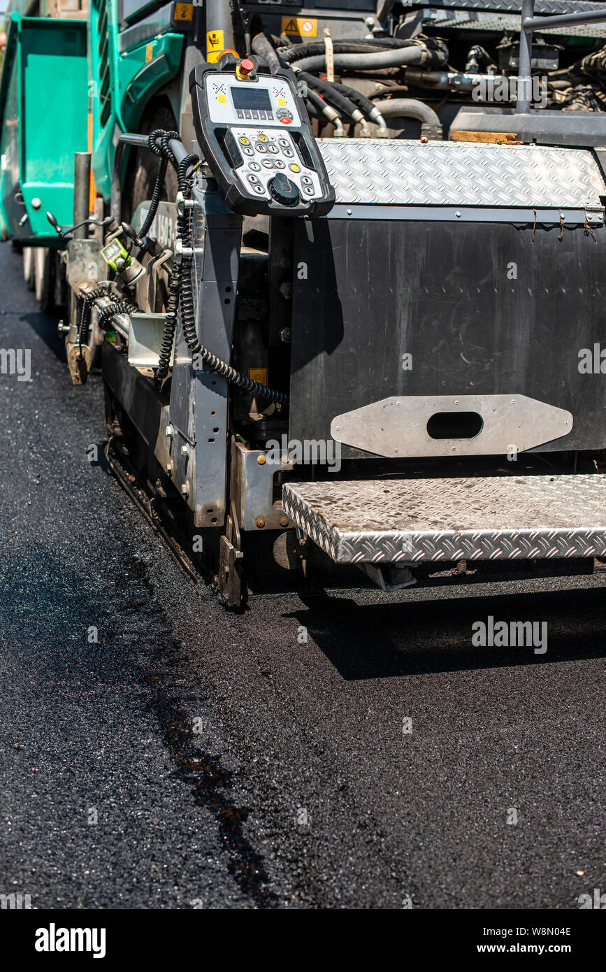Asphalting machine on the road. Close up Stock Photo - Alamy