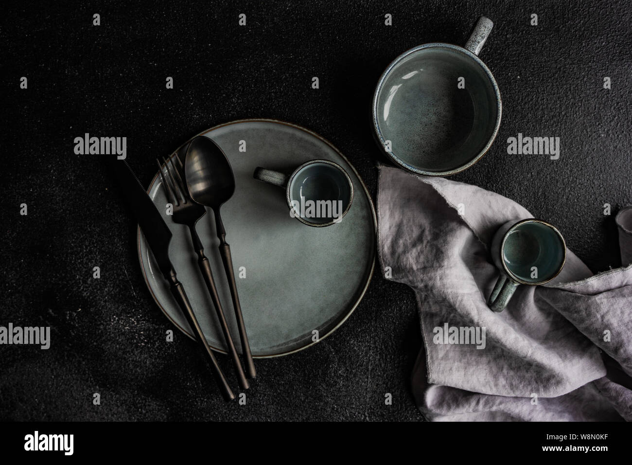 Minimalistic cutlery set in grey and black color with copy space on ...