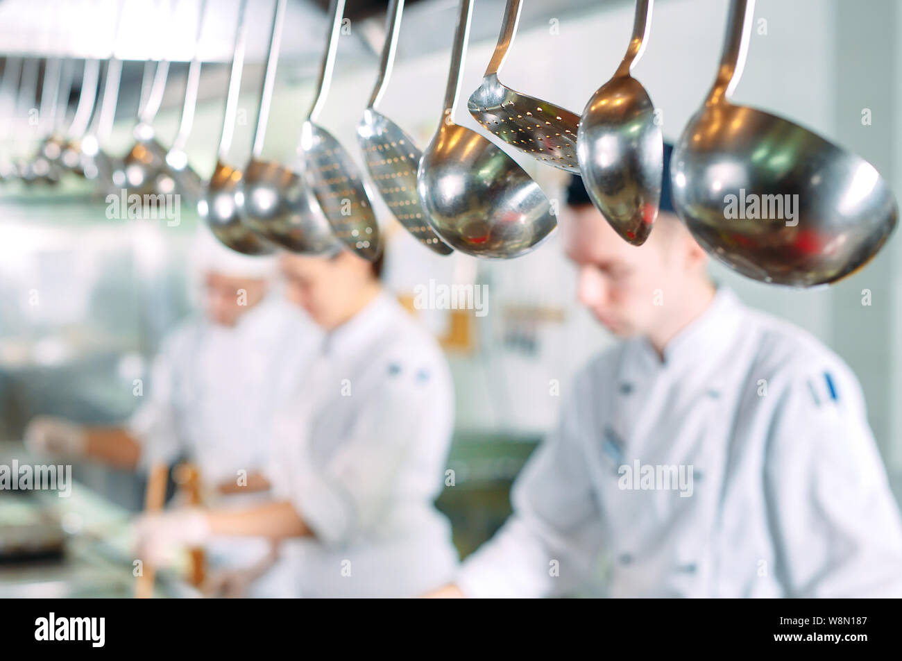 Modern kitchen. Cooks prepare meals on the stove in the kitchen of the ...