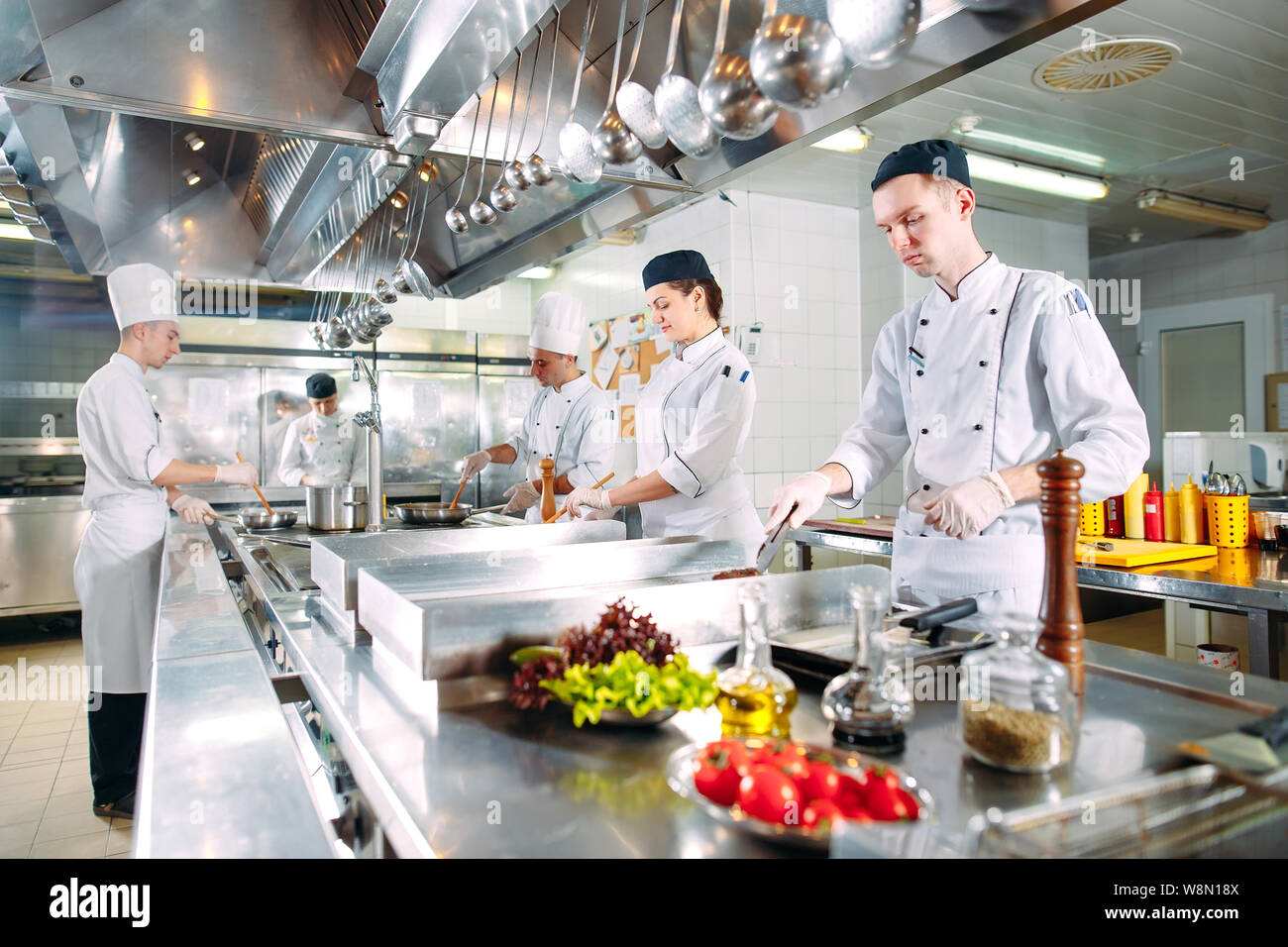 Modern kitchen. Cooks prepare meals on the stove in the kitchen of the ...