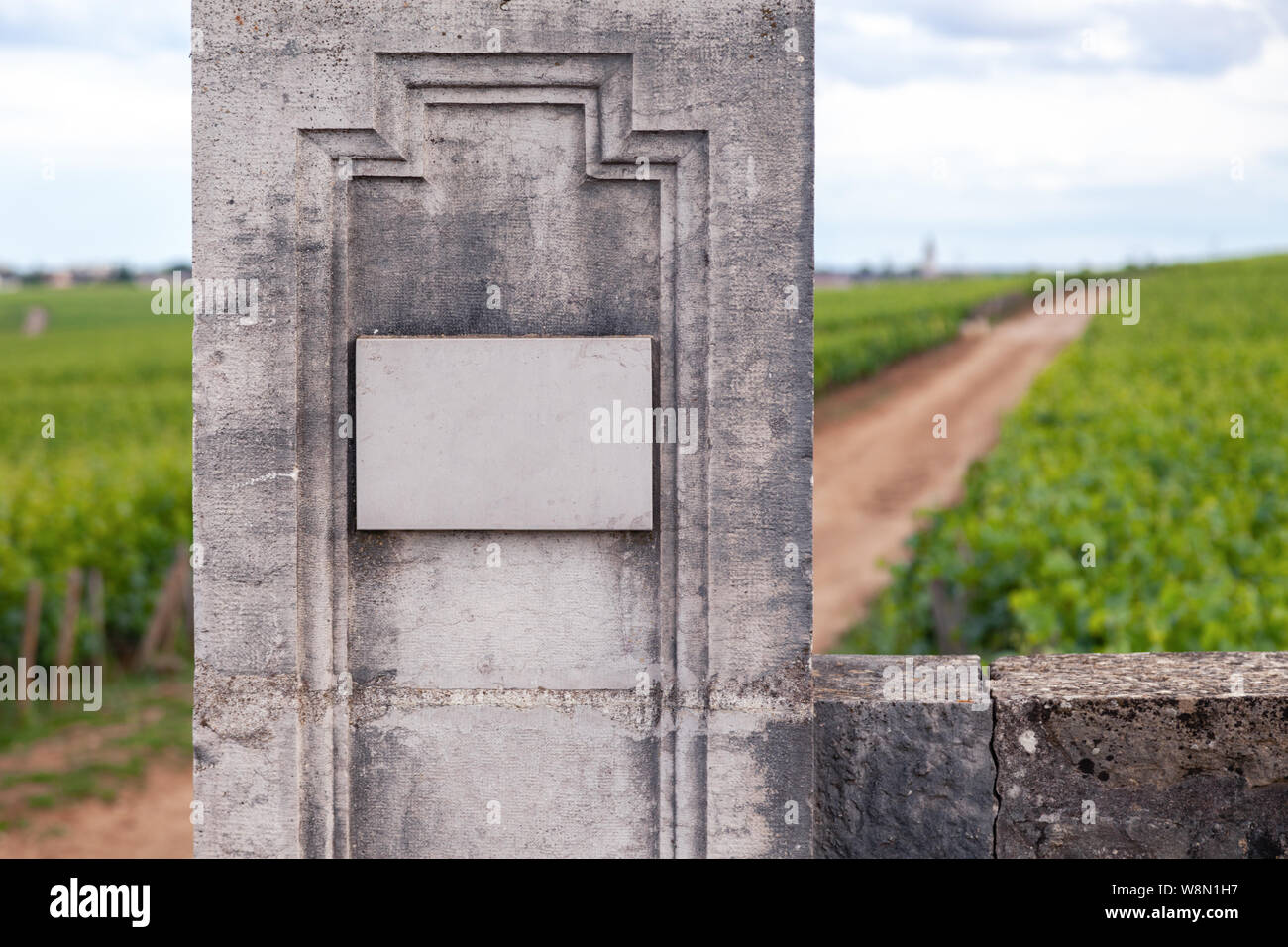 Closeup vintage rectangular shape stone aged plate, nameboard on gray ...