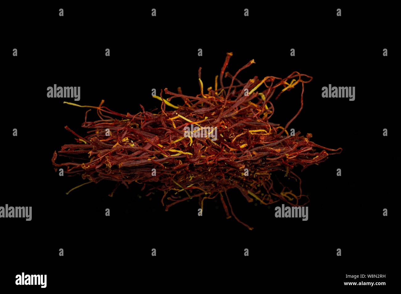 Lot of whole dry shaffron thread isolated on black glass Stock Photo ...
