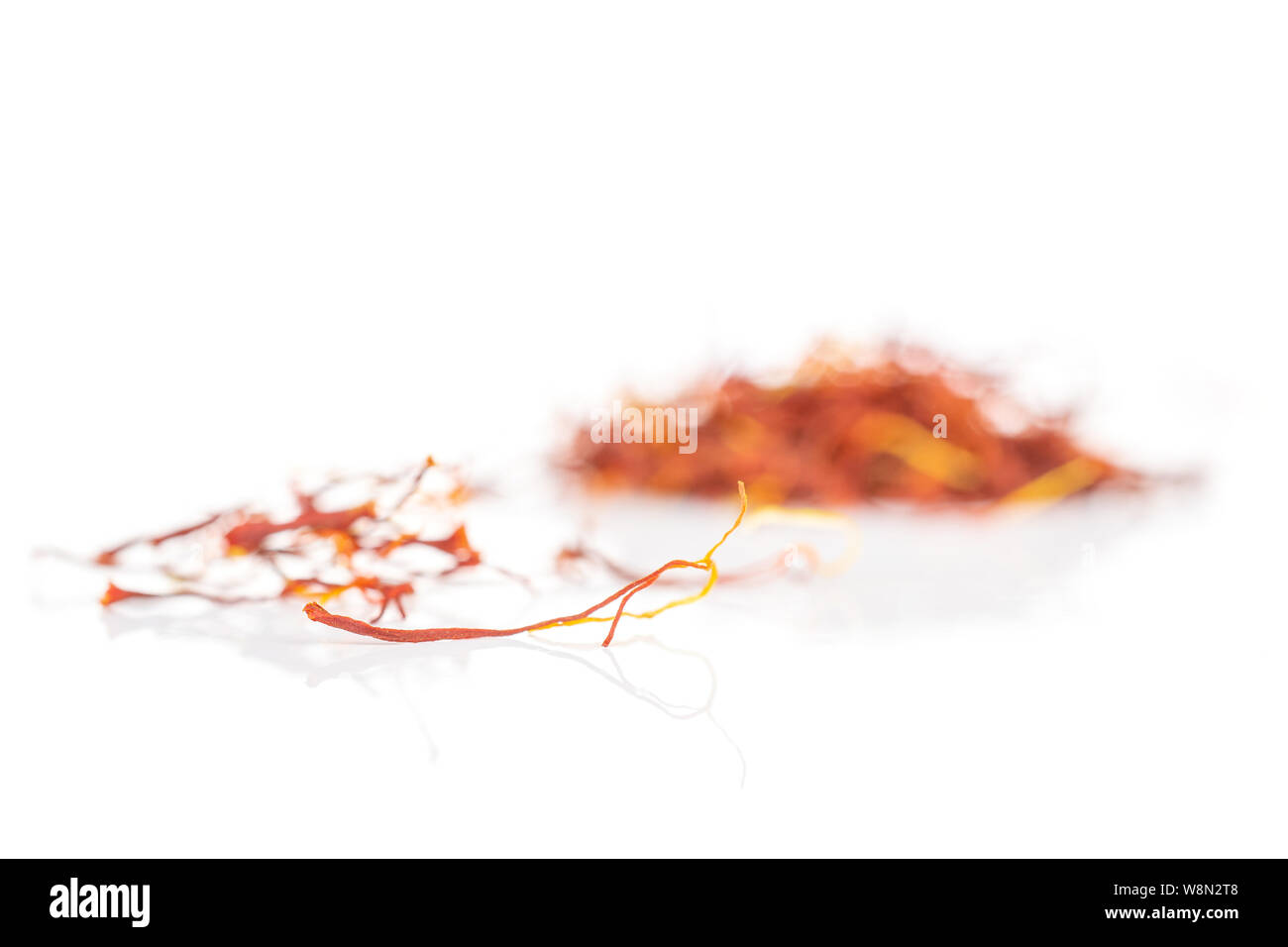 Lot of whole bright dry shaffron thread one in focus isolated on white ...