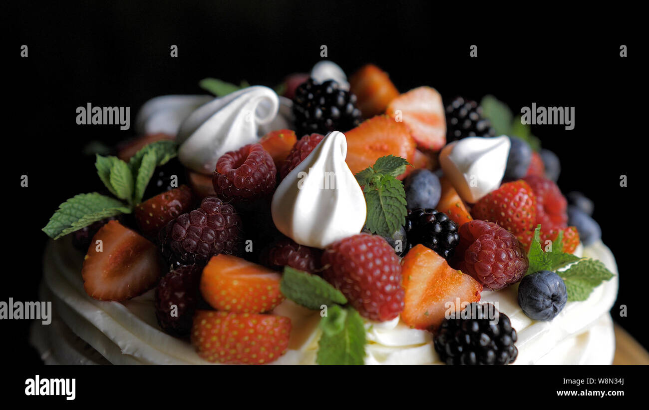 Dessert Anna Pavlova on a black background Stock Photo - Alamy