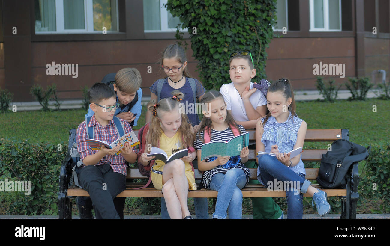 Cute kids study with books and notebooks on bench Stock Photo - Alamy