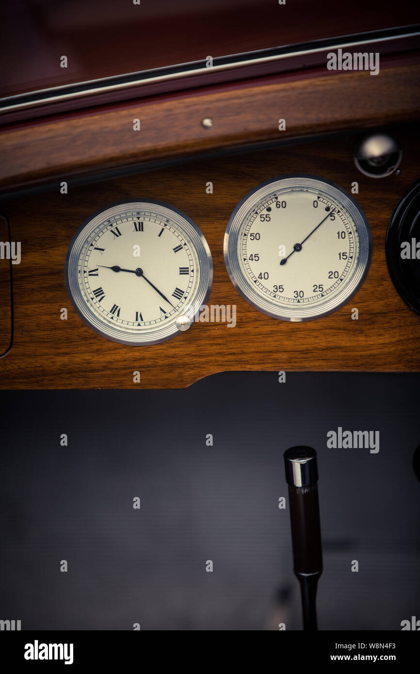 Color close up shot of a tachometer and a clock on a vintage car's ...