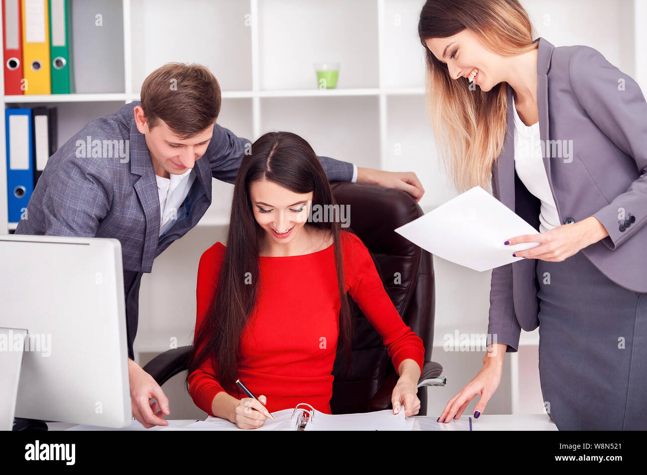 Young business team reading sticky notes on the work desk in office ...
