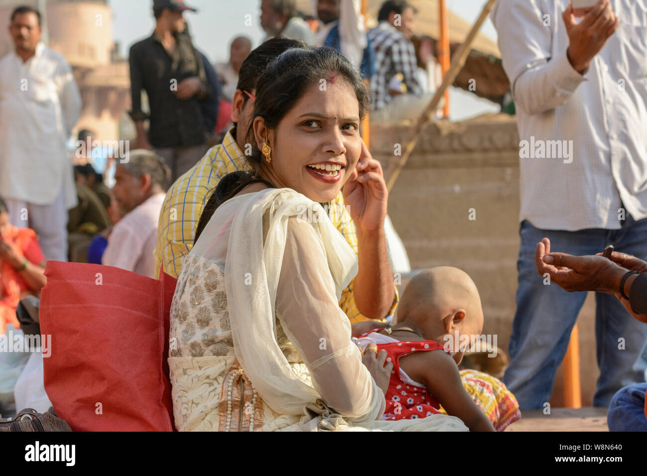 A young baby has her head shaved as part of the Hindu Mundan ritual to ...