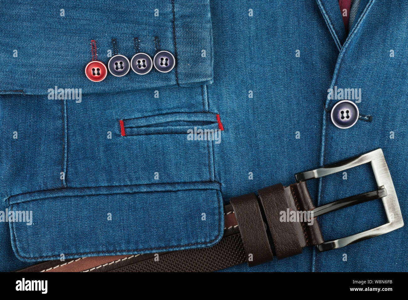 Leather belt lies on a denim jacket. Fashion background. Top view Stock ...