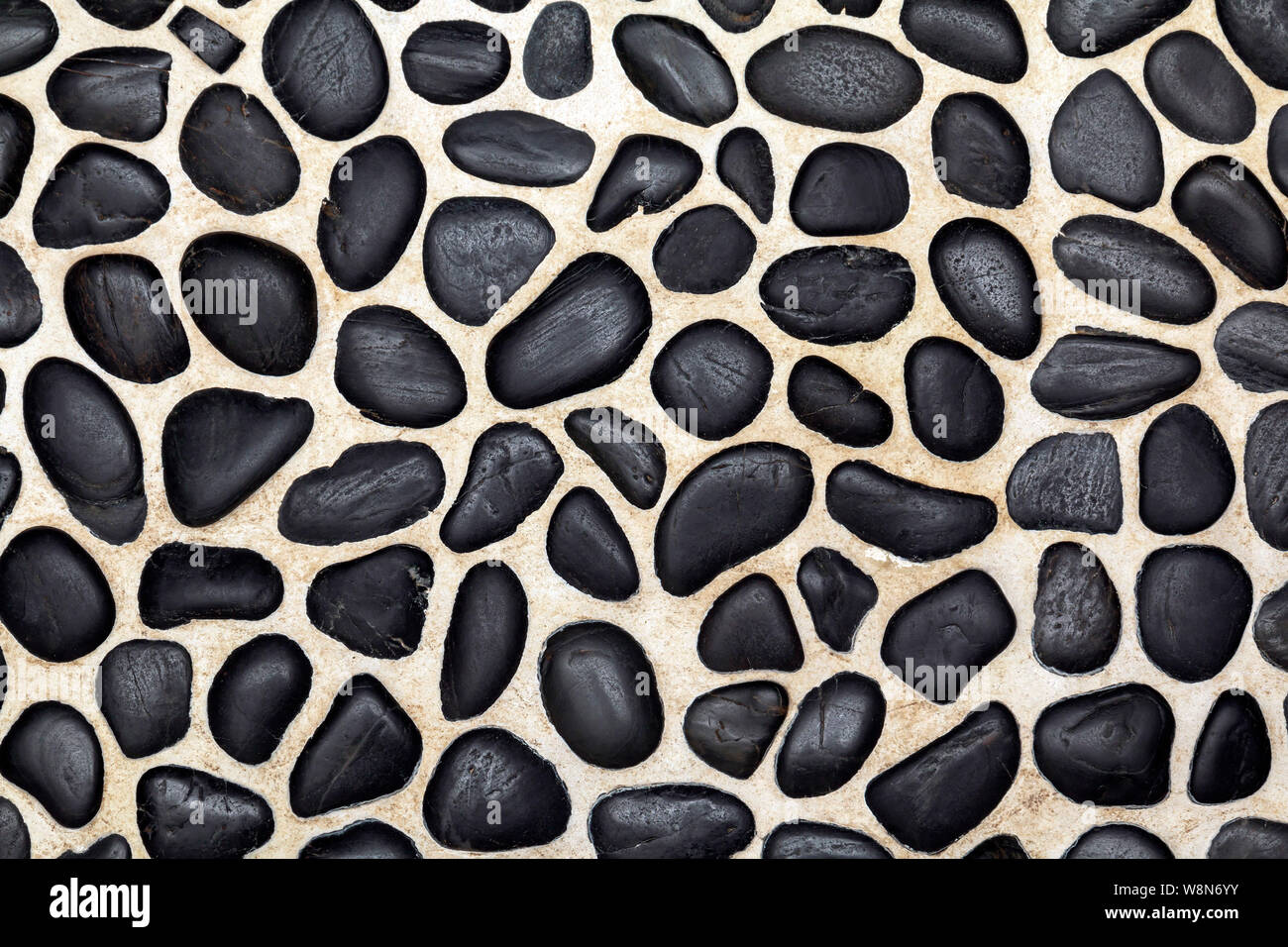 Black cobble pebbles set in a cement floor from overhead Stock Photo ...