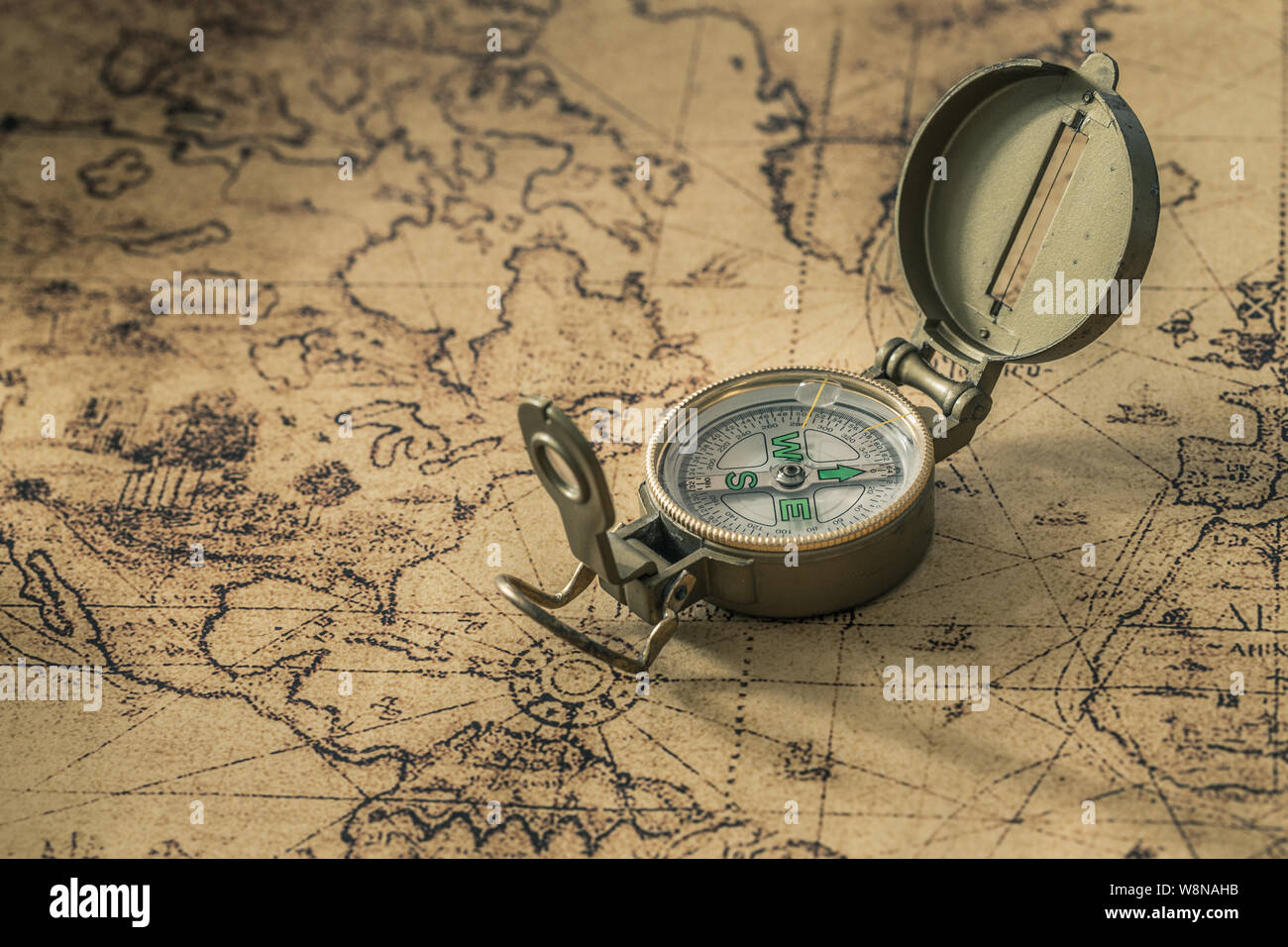 a compass on an old map showing the direction Stock Photo - Alamy