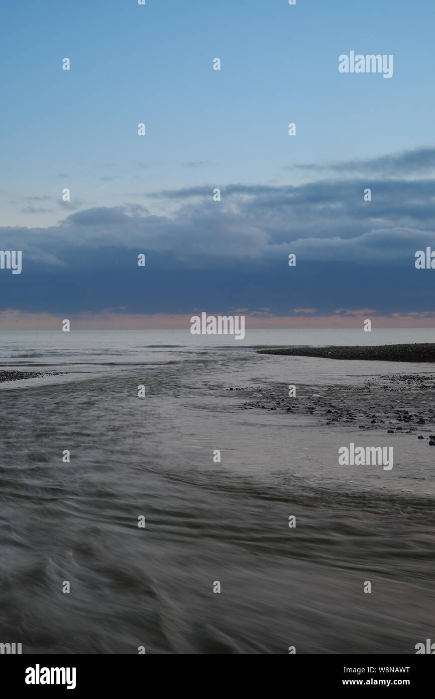 Outflow from the Cuckmere river estuary on a cool blue evening 2 Stock ...