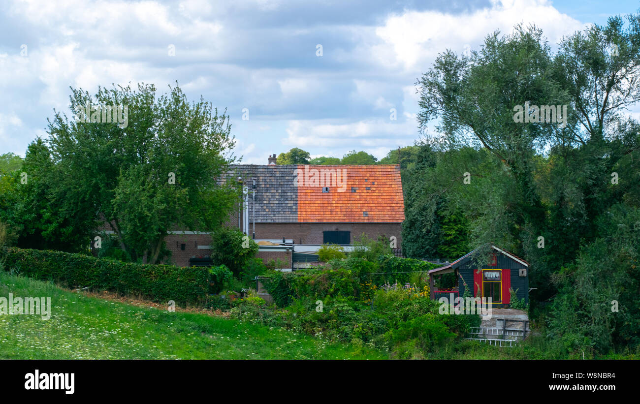 Small garden house next to a typical Dutch house Stock Photo - Alamy