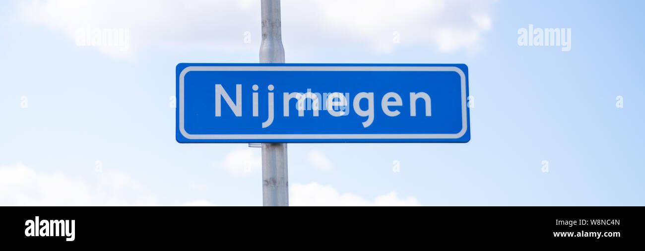 City limit sign of Nijmegen, The Netherlands in front of a blue summer ...