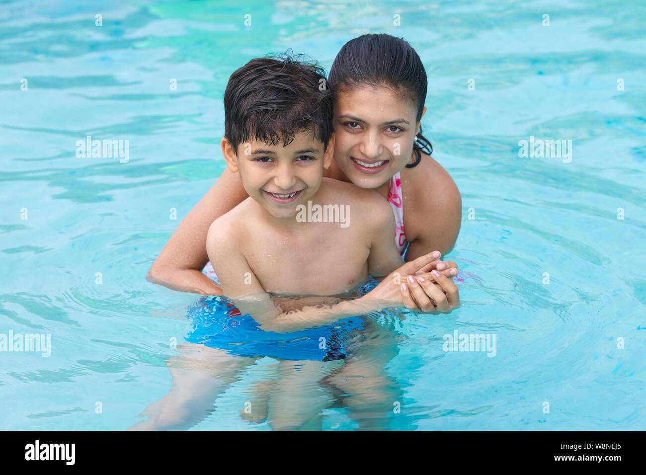 Mother and son playing in a swimming pool hi-res stock photography and ...