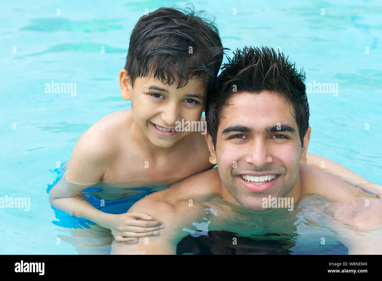 Father and son playing in a swimming pool Stock Photo - Alamy