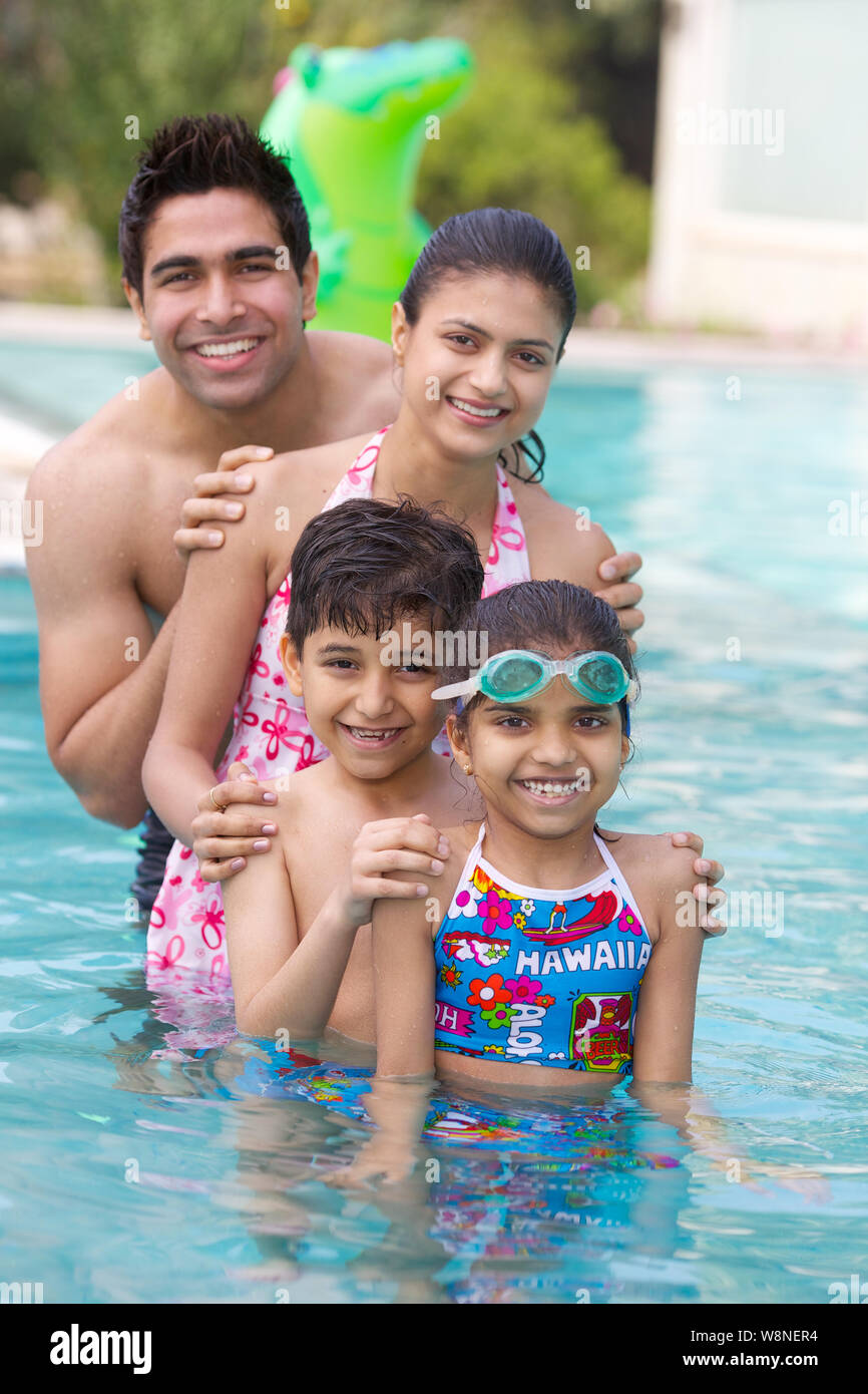 Family enjoying in a swimming pool Stock Photo - Alamy