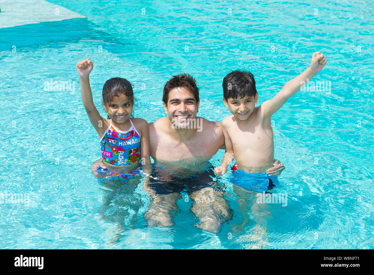 Family enjoying in a swimming pool Stock Photo - Alamy