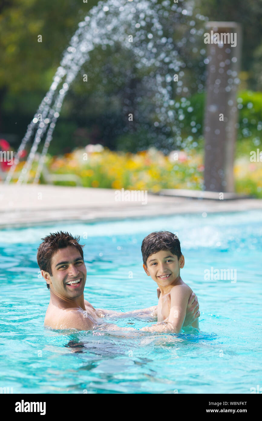 Father and son playing in a swimming pool Stock Photo - Alamy