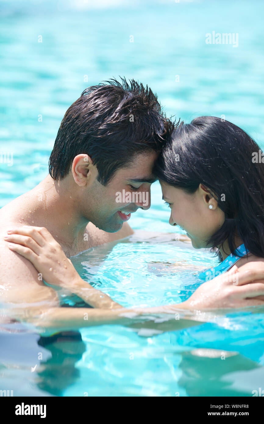 Young couple romancing in a swimming pool Stock Photo - Alamy