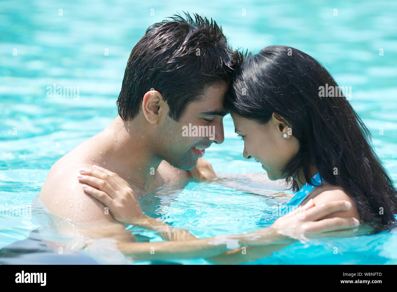Young couple romancing in a swimming pool Stock Photo - Alamy