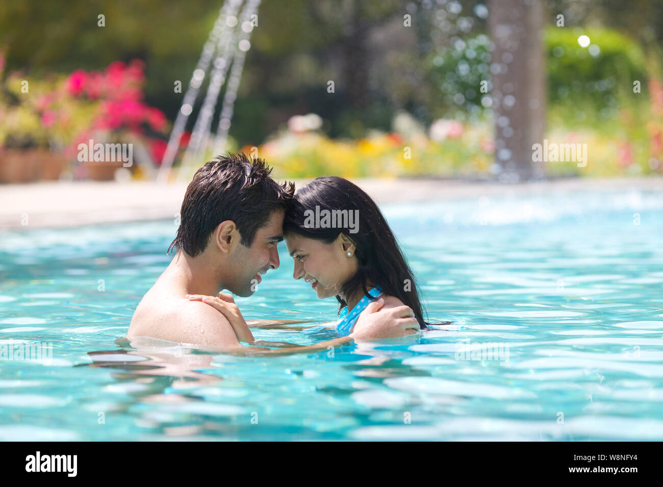 Young couple romancing in a swimming pool Stock Photo - Alamy
