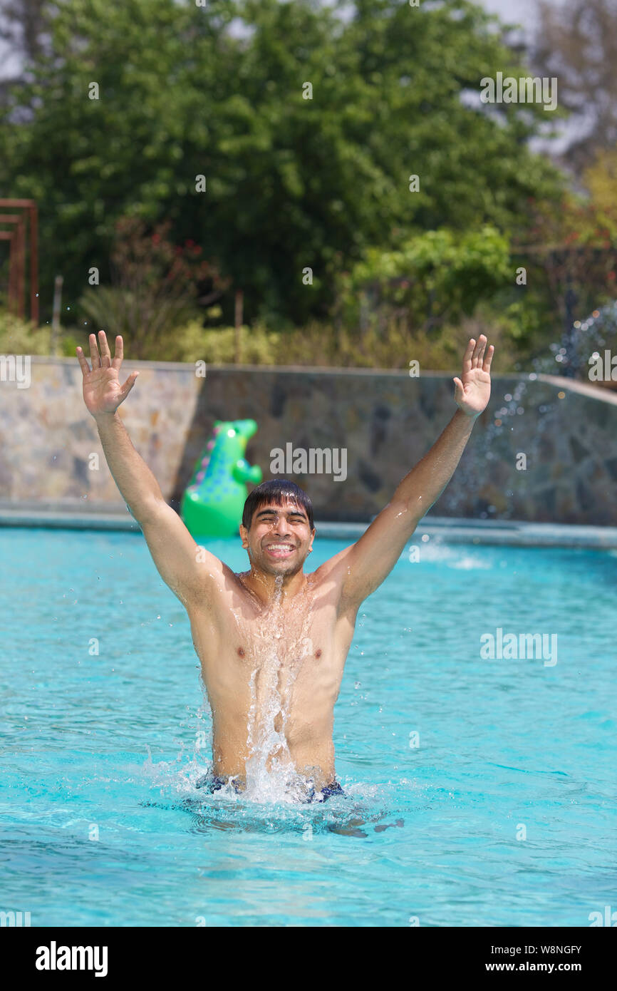 Young man enjoying in a swimming pool Stock Photo - Alamy