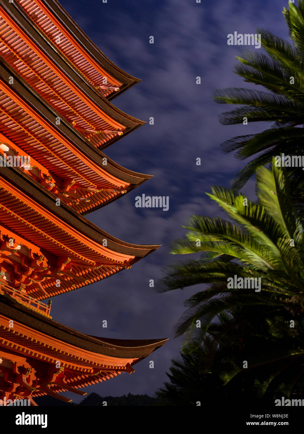 Red Pagoda and Palm Tree at night Stock Photo - Alamy