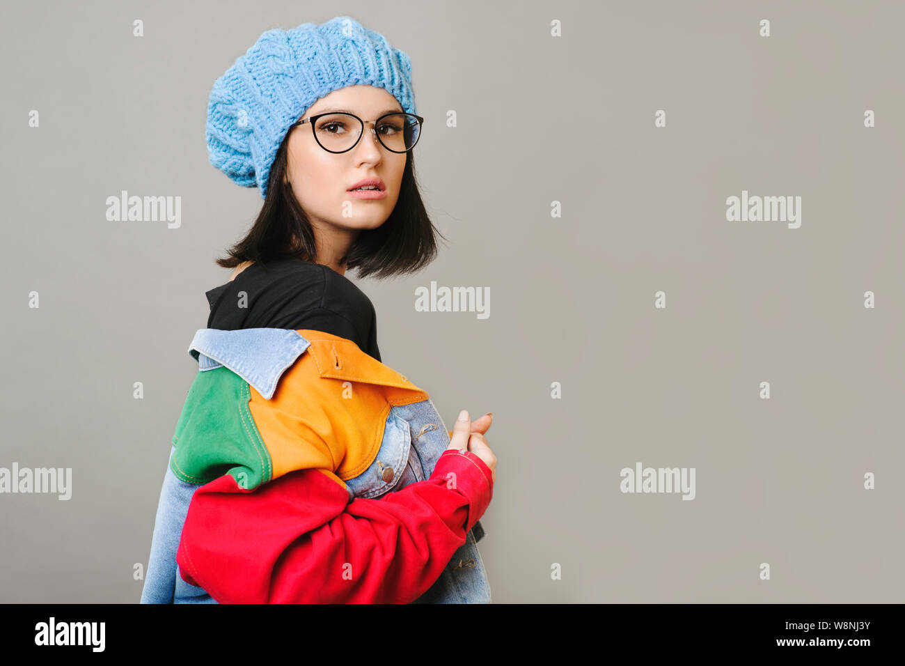 Woman taking off jacket hi-res stock photography and images - Alamy