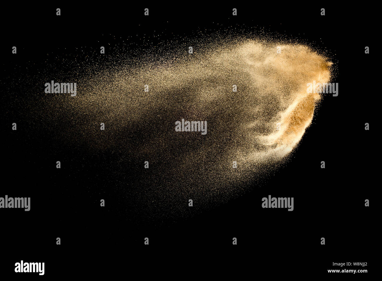 Brown colored sand splash against dark background. Dry river sand ...