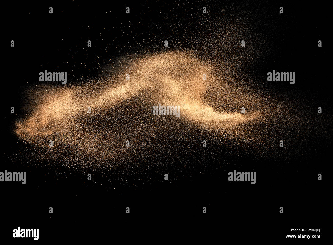 Brown colored sand splash against dark background. Dry river sand ...