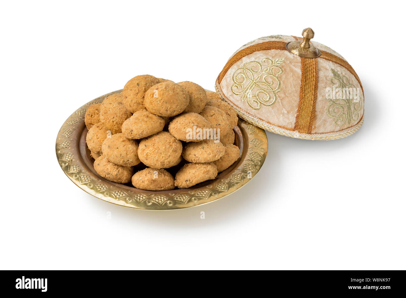 Traditional ghoriba cookies in a festive tagine isolated on white ...